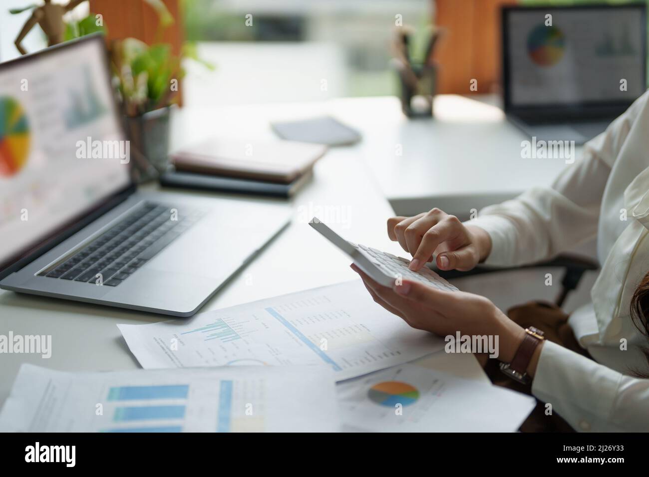 Close up hand of accountant working with computer and calculator for ...