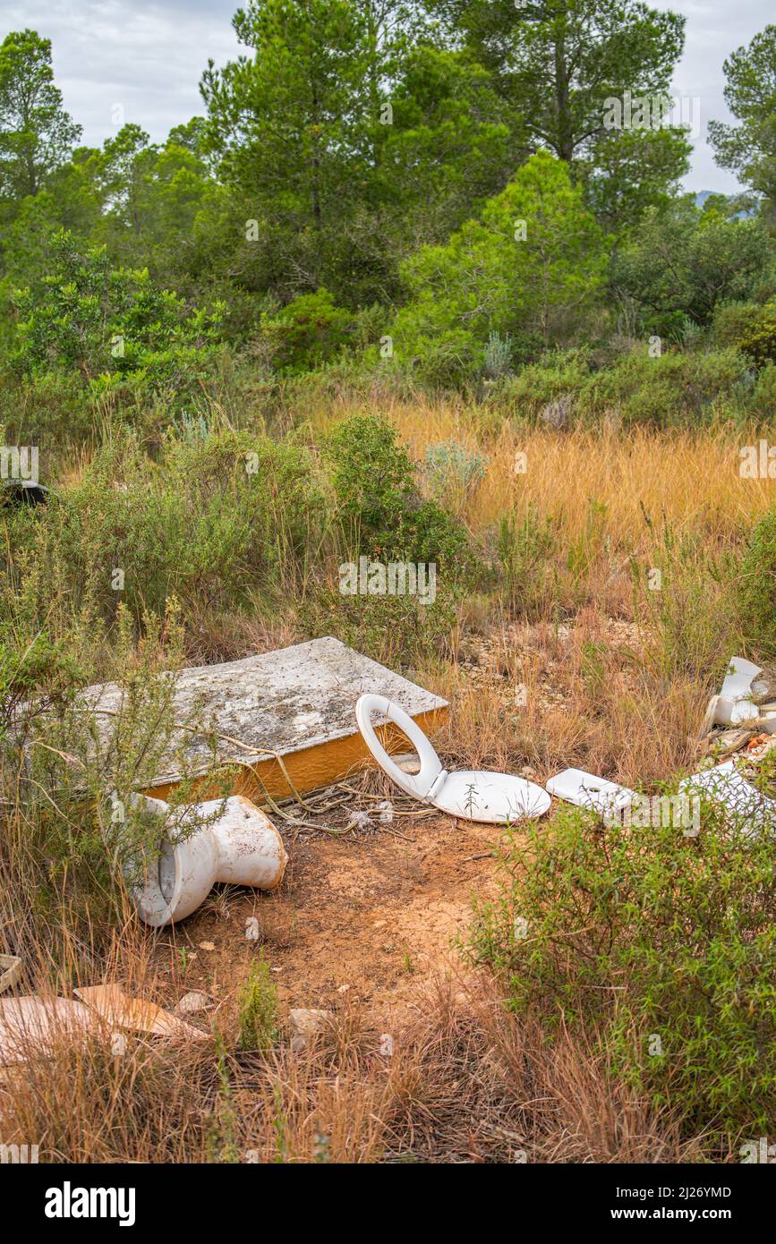 Rubble garbage lying in forest at a rural road in Tarragona, Costa ...