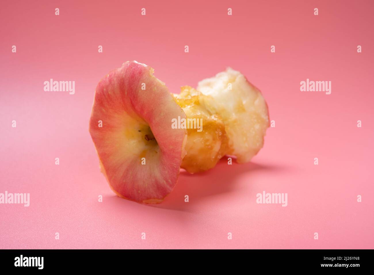 core of a red apple on pink background Stock Photo - Alamy