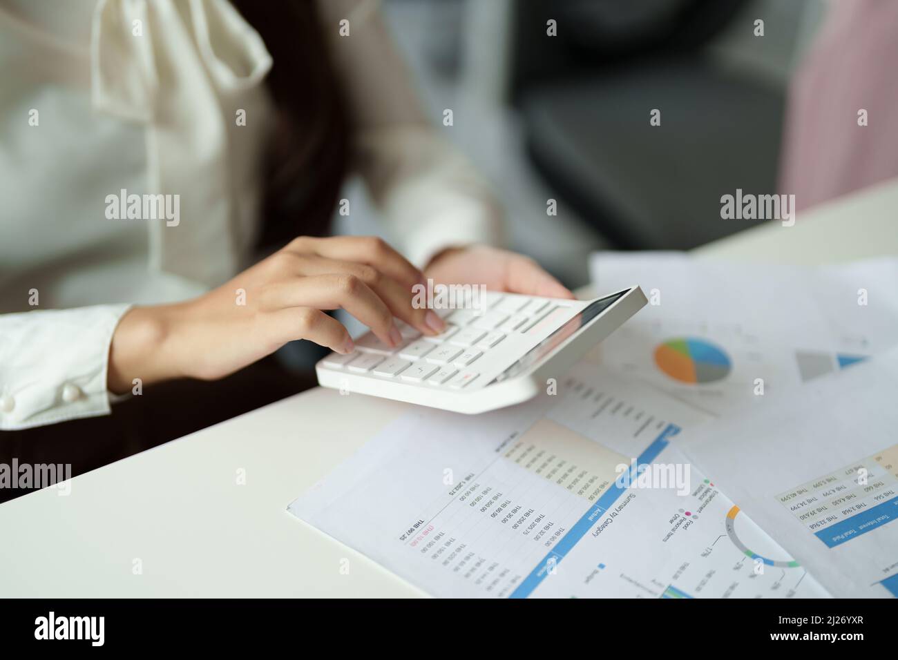 Close up hand of accountant working with computer and calculator for ...
