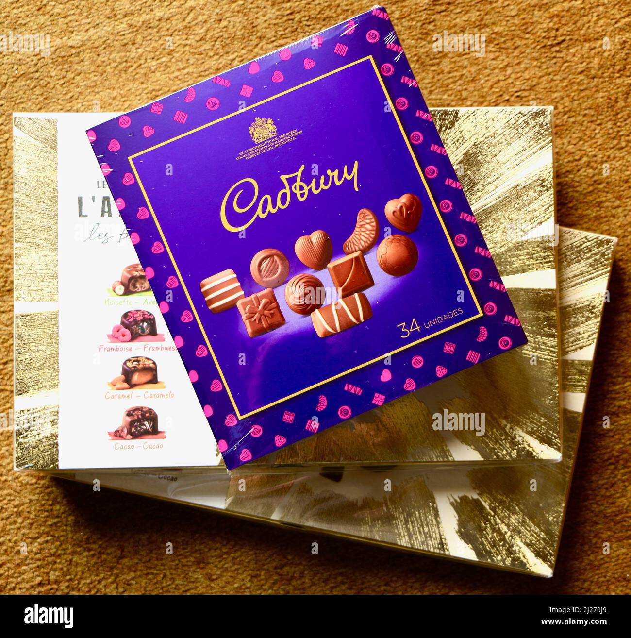 Photo of a box of Cadbury chocolates on top of boxes of Nestle ...