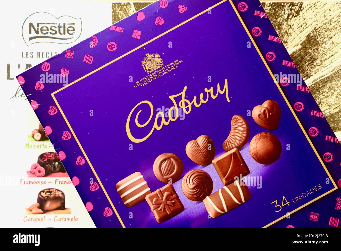 Photo of a box of Cadbury chocolates on top of boxes of Nestle ...