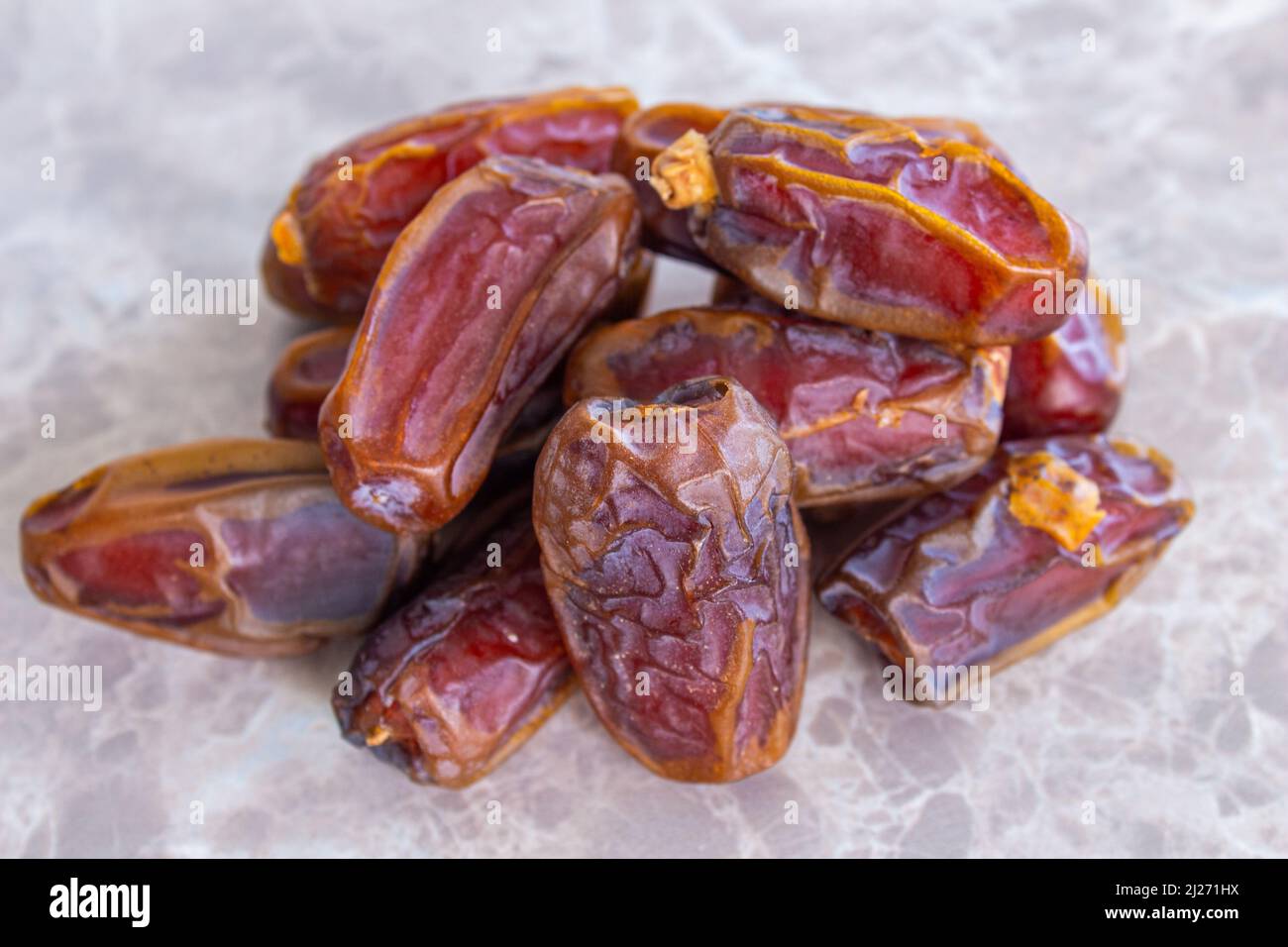 Dried dates. Stack of date fruits on marble background Stock Photo - Alamy
