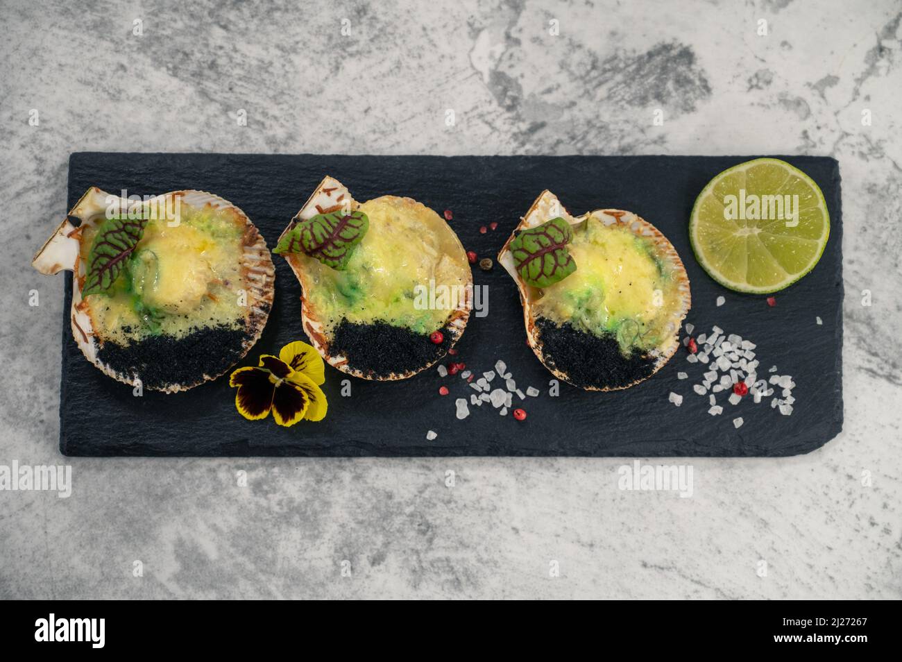 Delicacy roasted scallops with cheese spices and chuka algae Stock ...