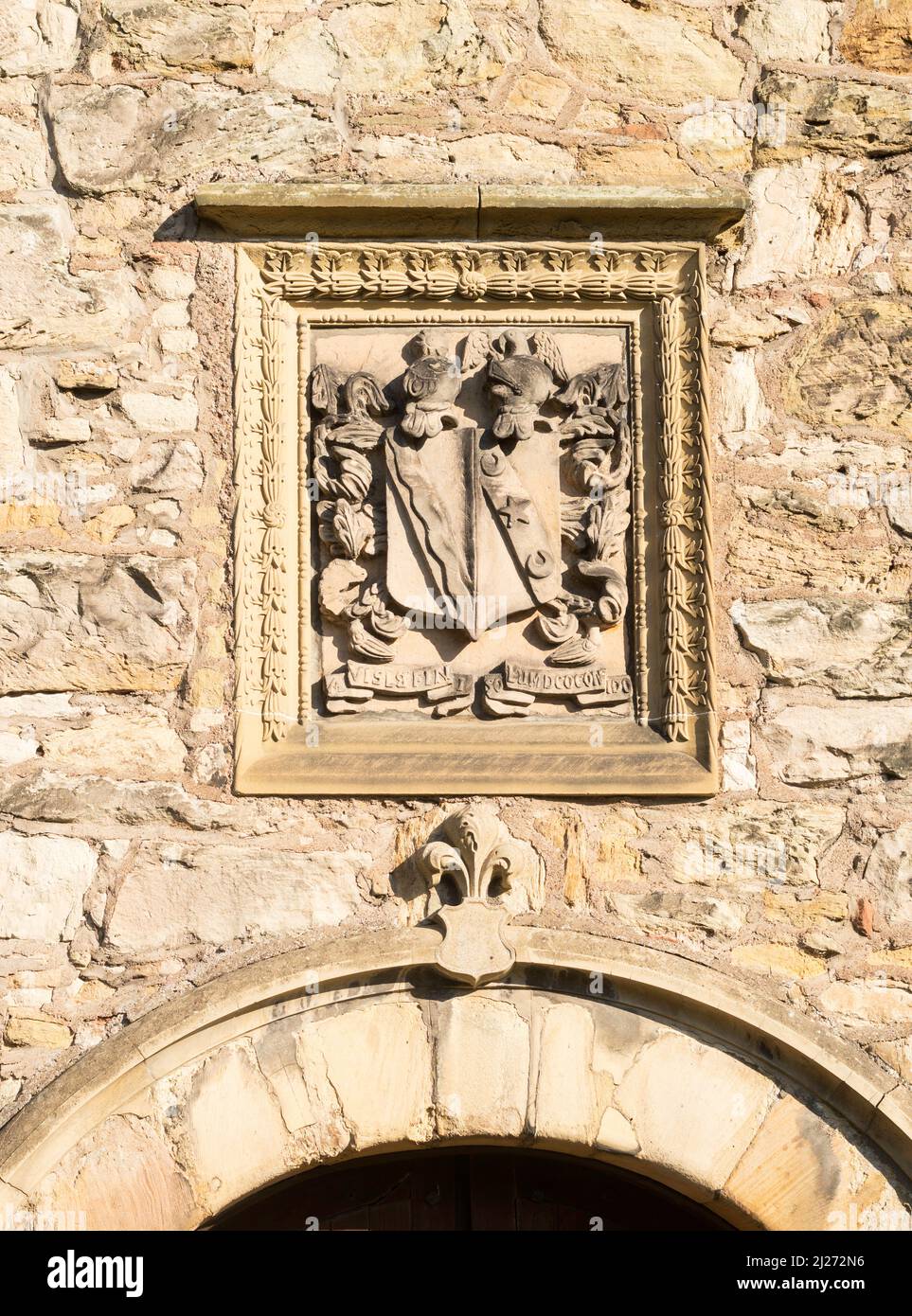 Carved stone coat of arms on the west façade of Queen Mary's house in ...