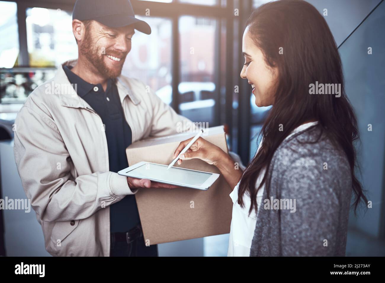 This was simple and easy. Shot of a cheerful delivery man handing over ...