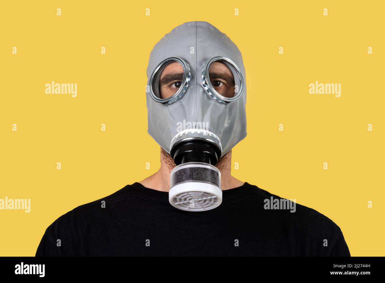 Man with a gas mask on yellow background Stock Photo - Alamy