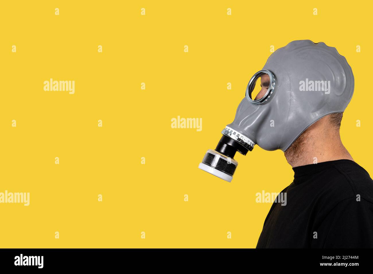 Man with a gas mask on yellow background Stock Photo - Alamy