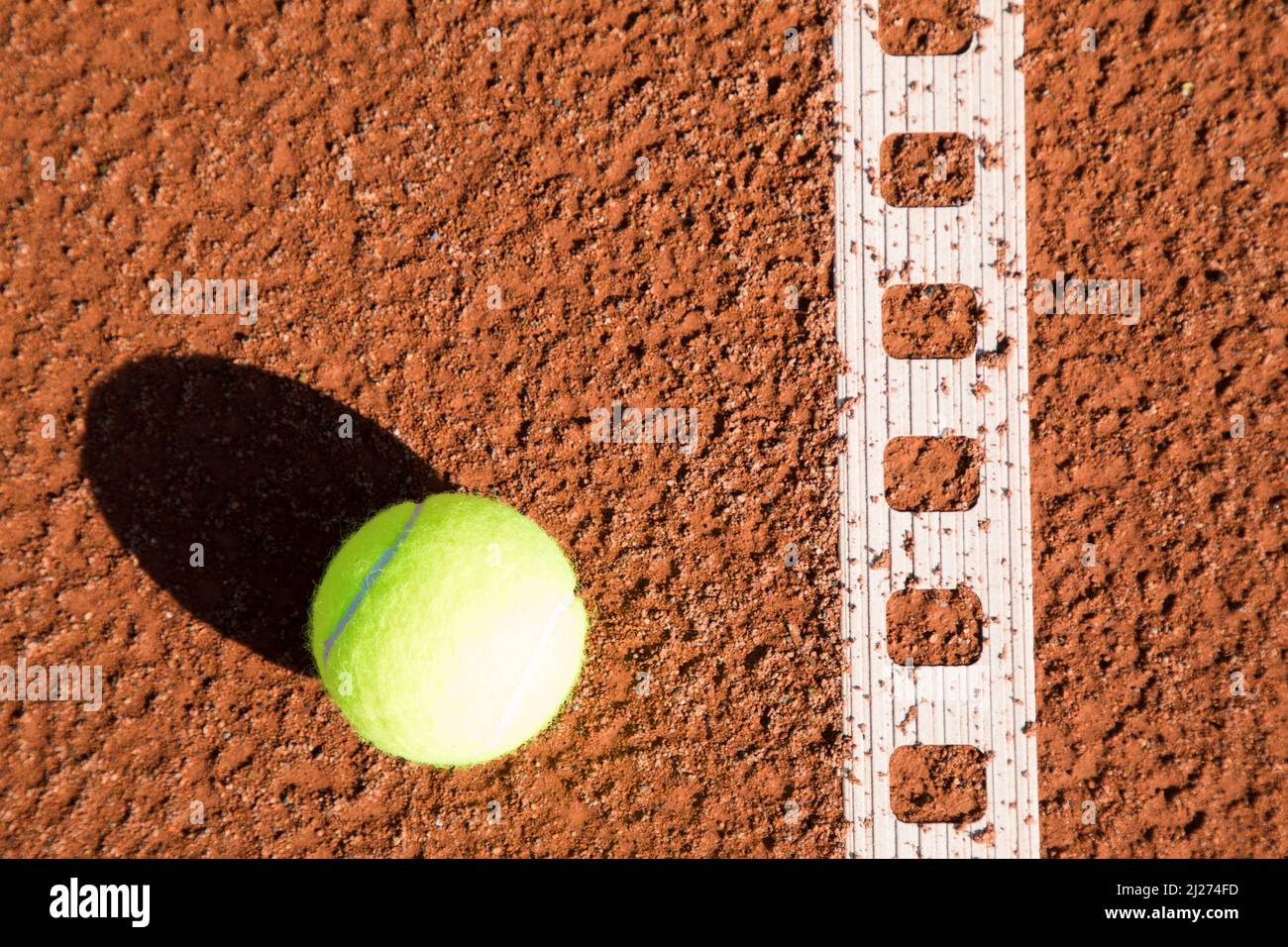 tennis ball with line on a sand court Stock Photo - Alamy
