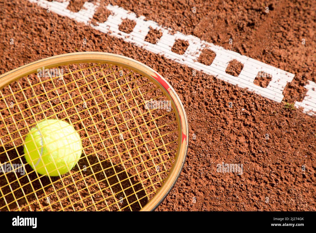 tennis raquet with tennis ball on ash court Stock Photo - Alamy