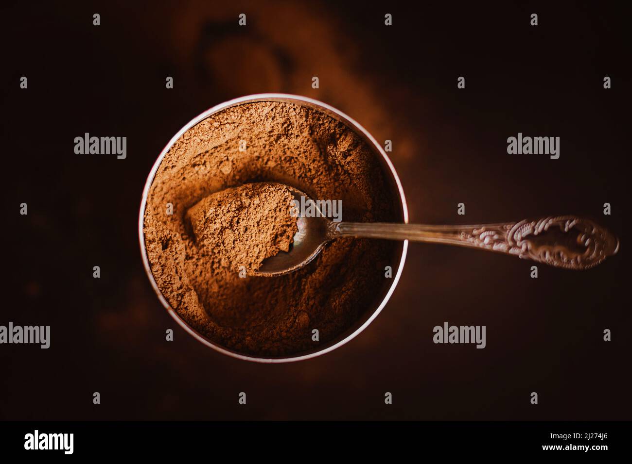 In an open jar there is a fragrant natural cocoa powder and a beautiful ...