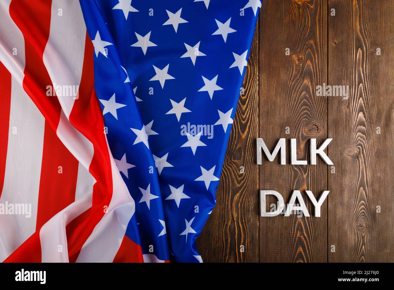 the word MLK day laid with silver metal letters on wooden surface with ...