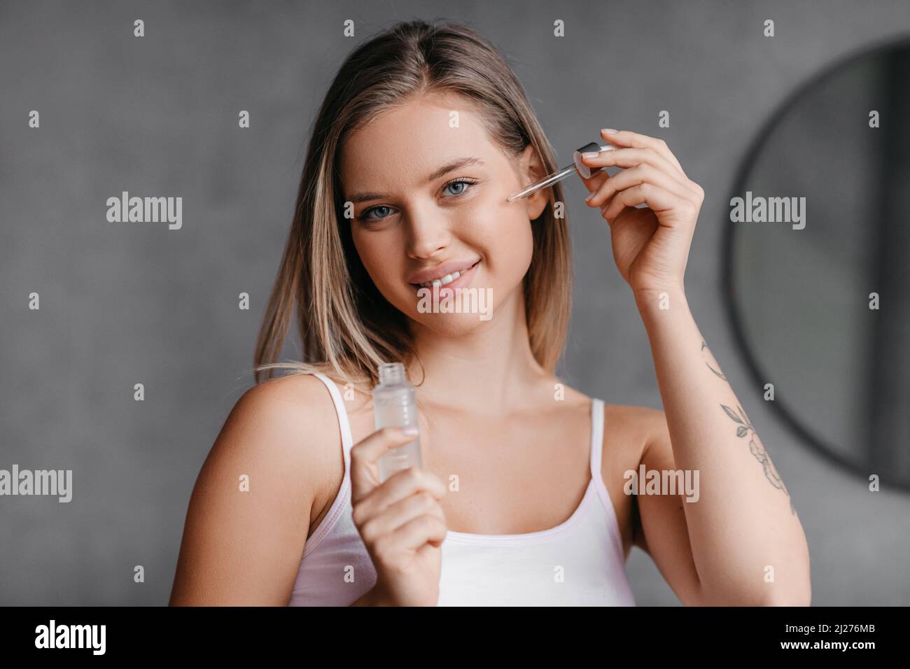 Beauty cosmetics for young skin. Pretty lady applying moisturizing ...