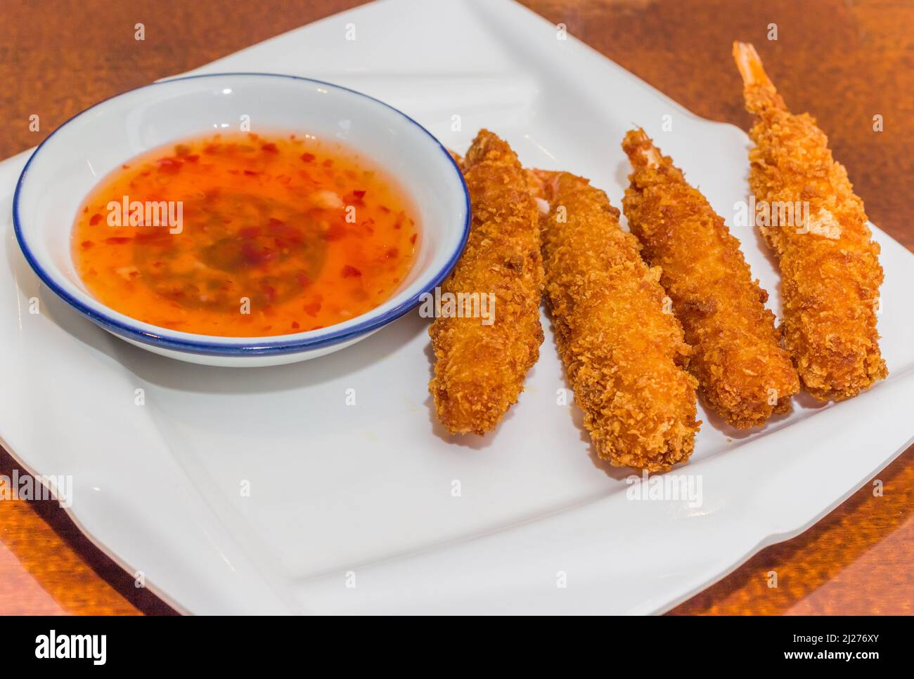 Traditional crispy breaded chinese shrimp served with spicy red sauce ...