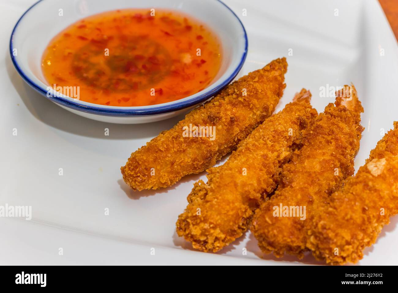 Traditional crispy breaded chinese shrimp served with spicy red sauce ...