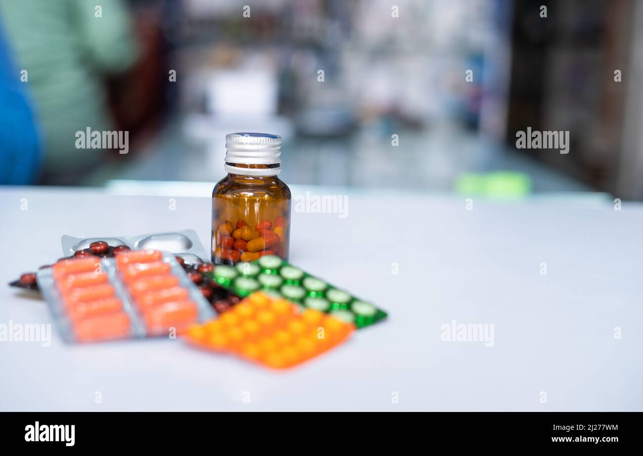 tablets or pills on counter of pharmacy store for customer or patient ...