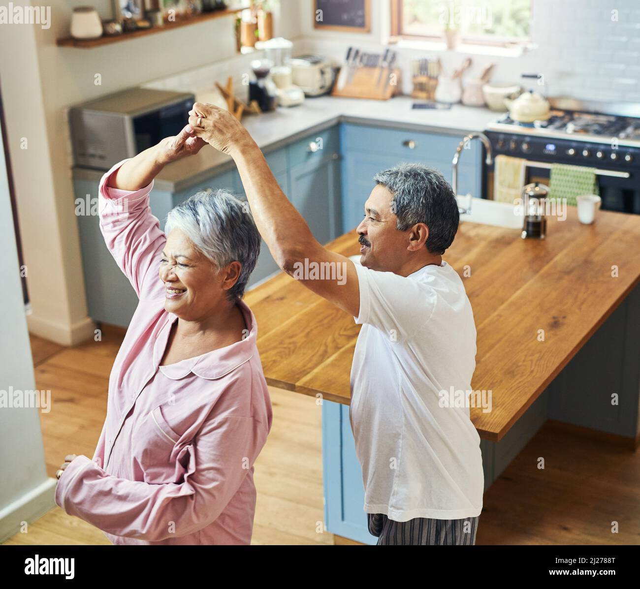 Getting in a bit of morning dancing. Shot of a cheerful elderly couple ...