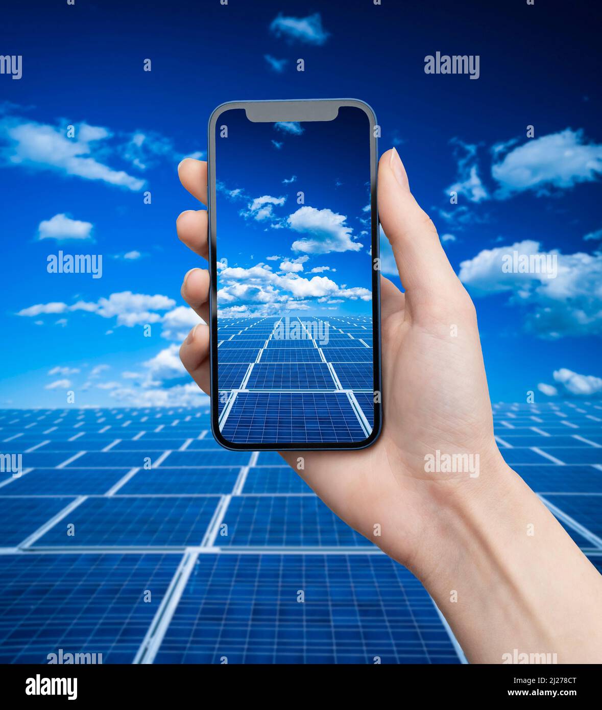 Hand holds mobile phone on solar panels Stock Photo - Alamy