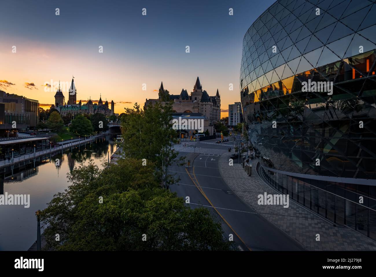the Ottawa Convention Centre, at sunset, with Parliament and the Rideau ...