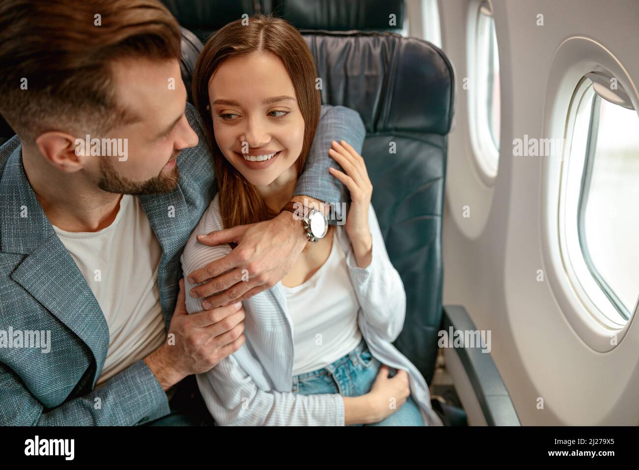 Happy couple in love traveling together by airplane Stock Photo - Alamy