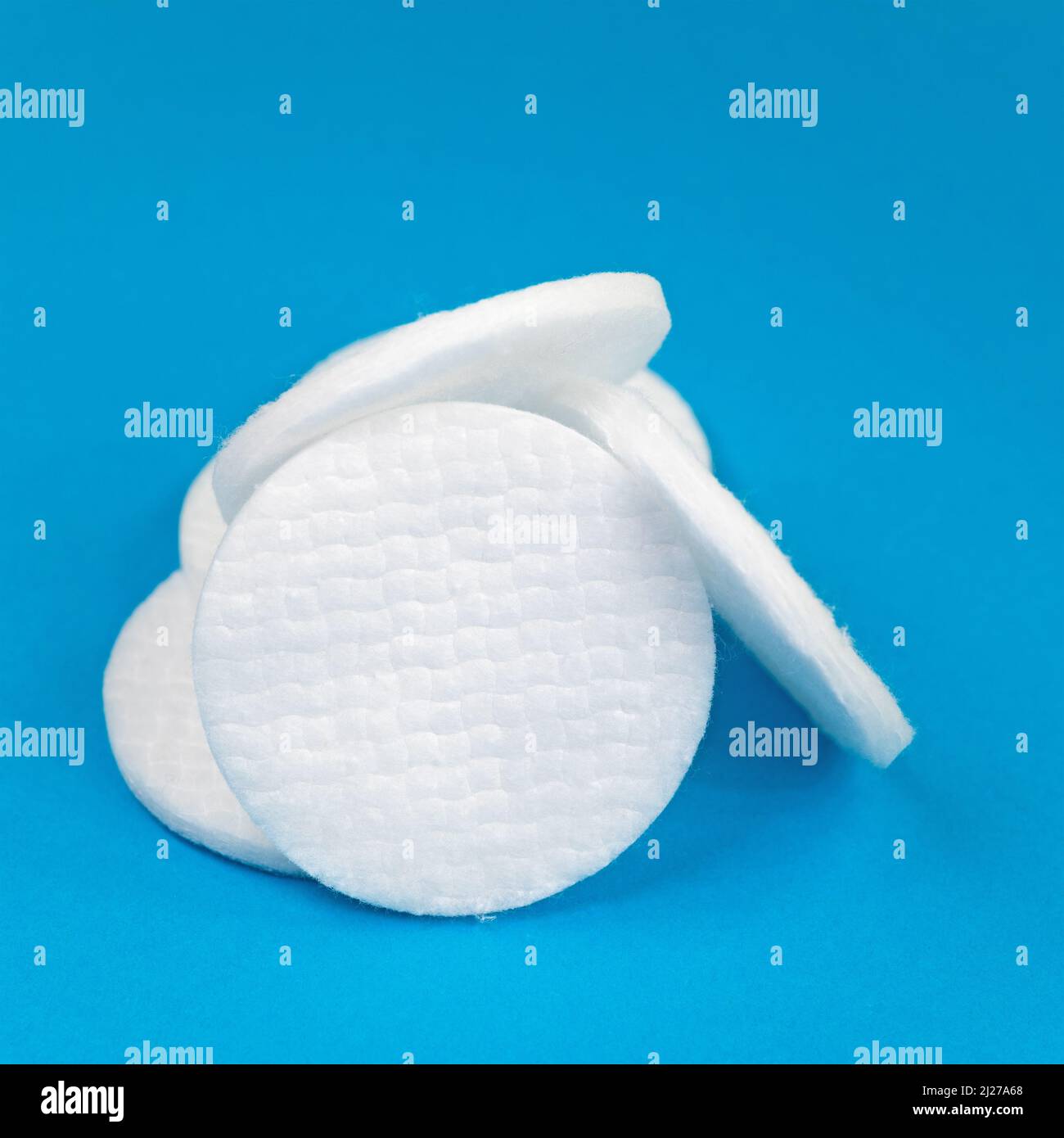 Cotton pads isolated against blue background Stock Photo - Alamy
