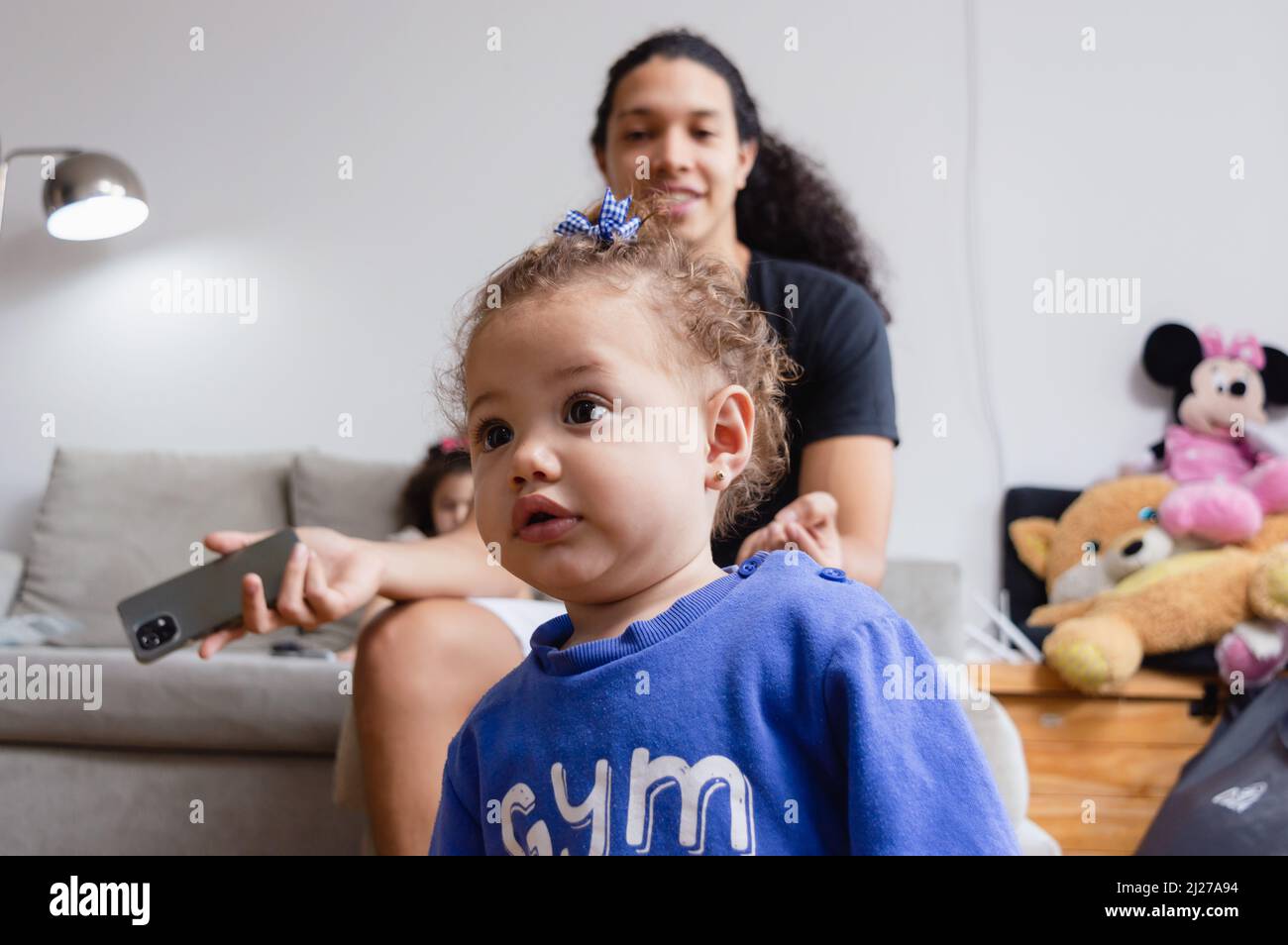 portrait of cute caucasian baby in the living room taking small steps ...
