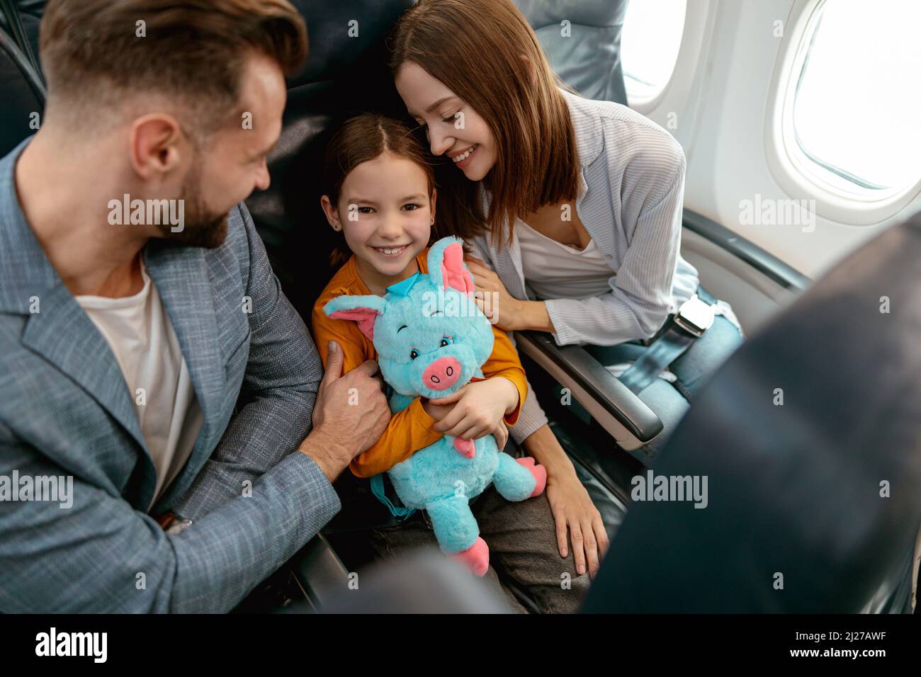 Happy family with one child traveling by airplane Stock Photo - Alamy