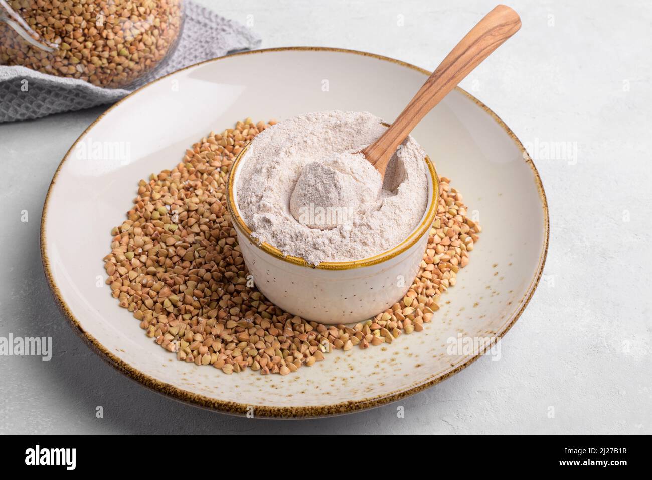 Buckwheat flour in a bowl buckwheat grain on a napkin top view Stock ...
