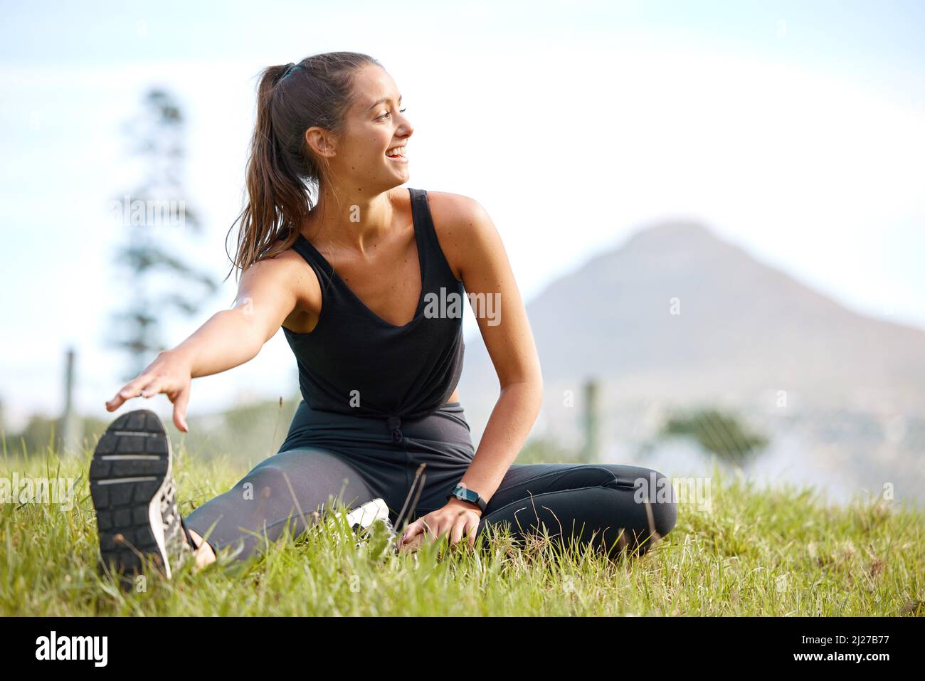Make sure you always start with a really good stretch. Shot of a sporty ...