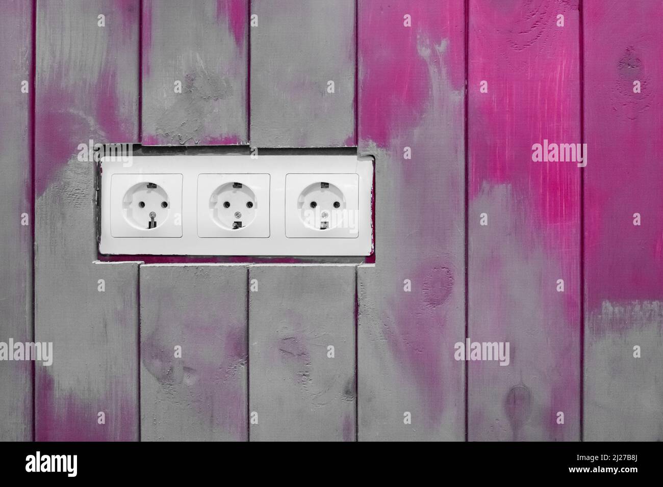 White triple power socket electric outlet plug voltage on wooden ...