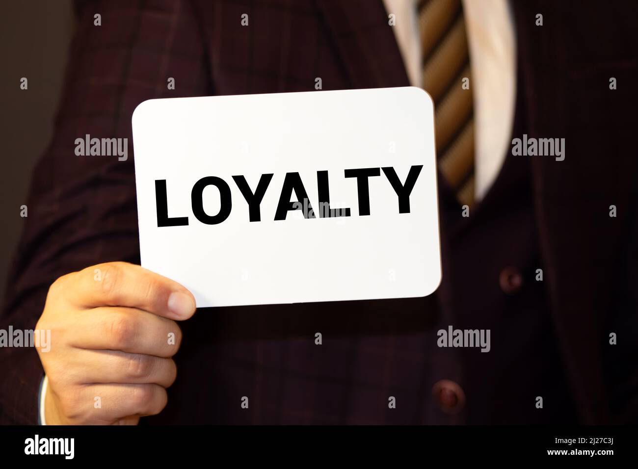 LOYALTY word on the card shown by a man Stock Photo - Alamy