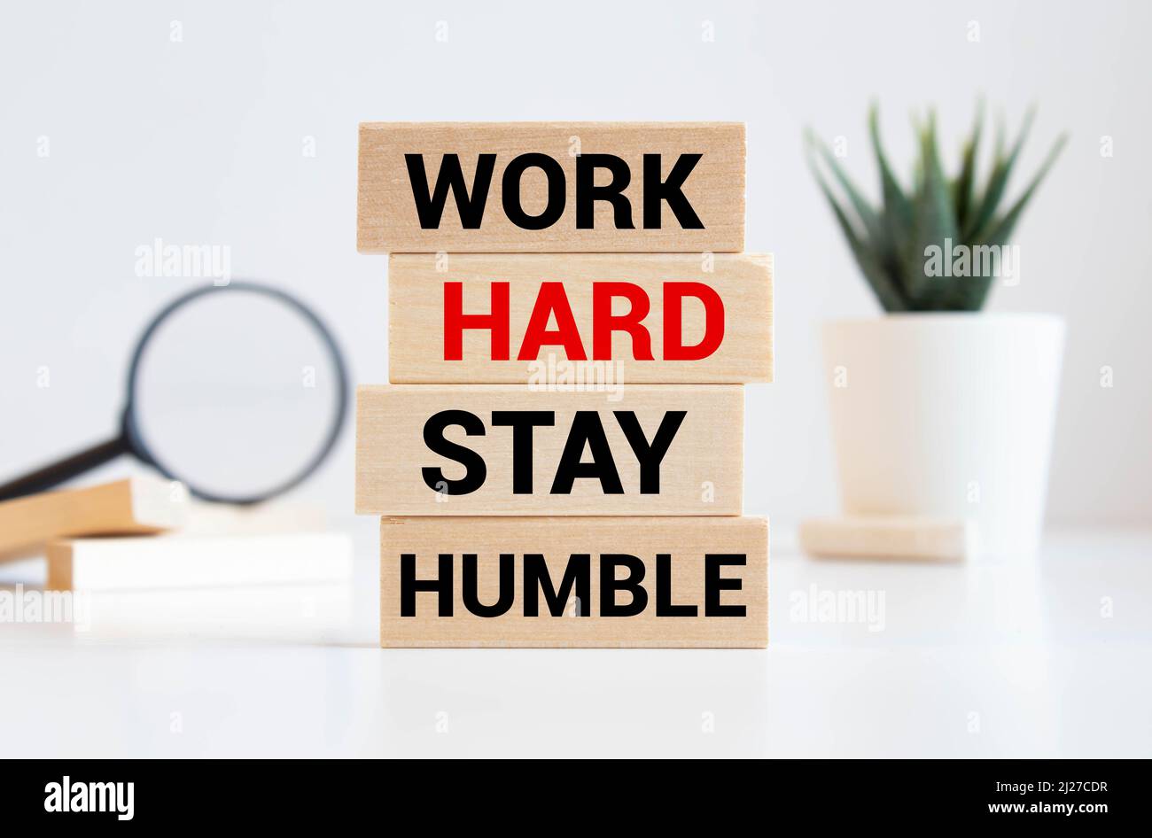 Work hard stay humble hanging light box sign board. Wooden block Stock ...