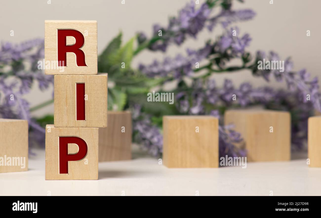 Rest in peace. Wood block RIP with old Plumeria flower and light on ...