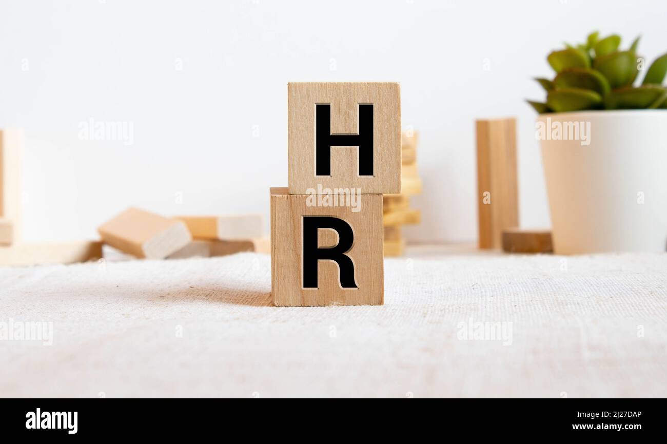 Wooden cube block building the word HR at the center on grid line note ...