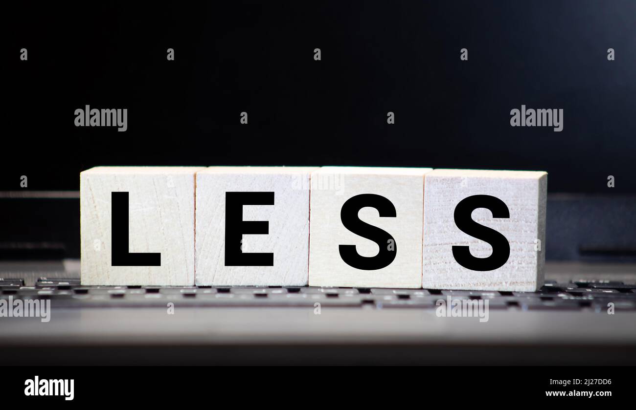 Less word on wooden cubic blocks. Spend less or cut costs business ...