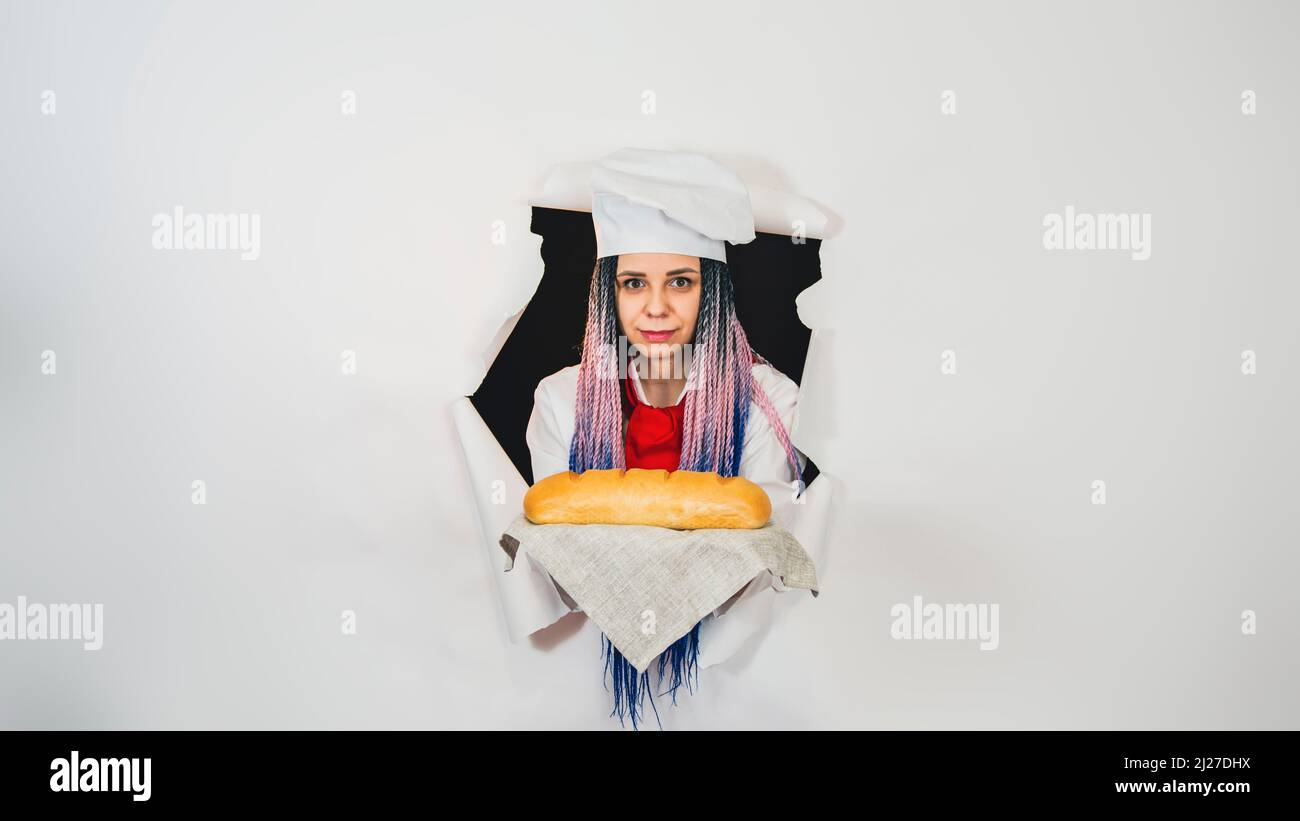 Female cook with loaf in hole of white background Stock Photo - Alamy