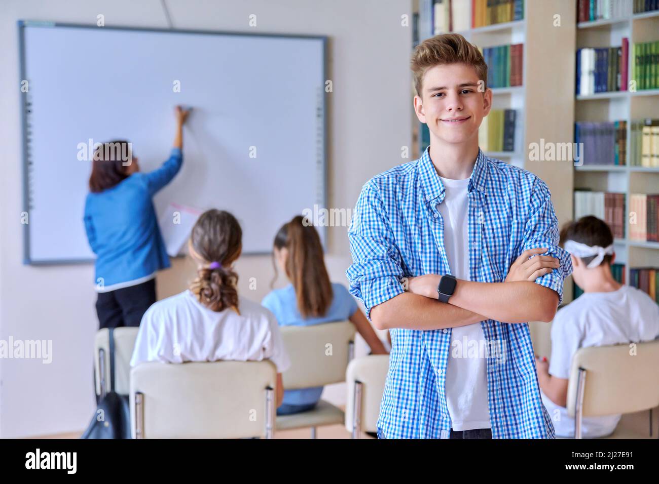Teenage guy in the classroom looking at the camera Stock Photo - Alamy