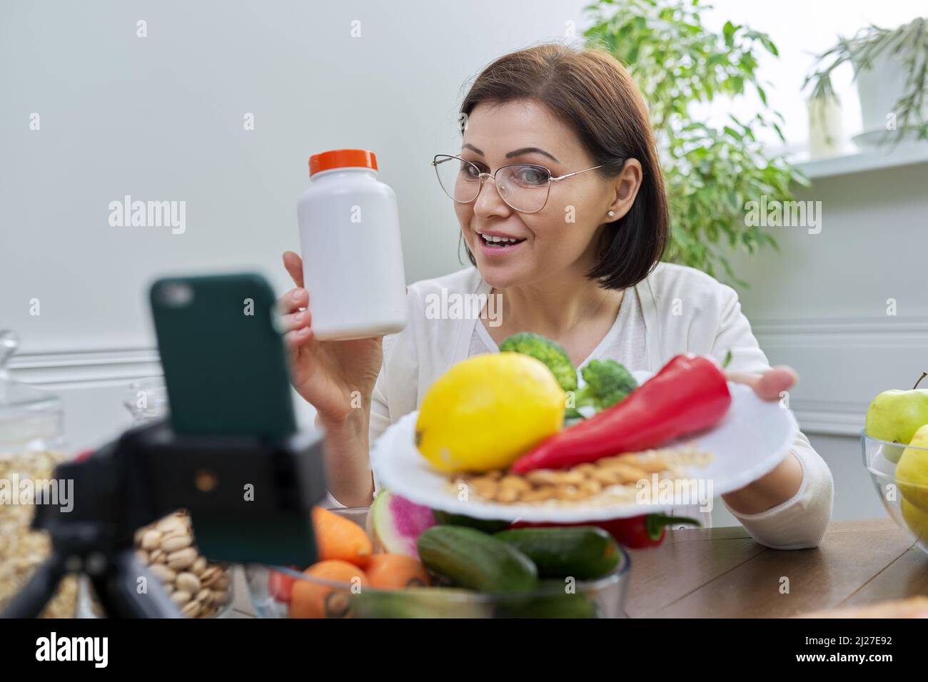 Woman recording video stream about healthy eating, vitamins ...