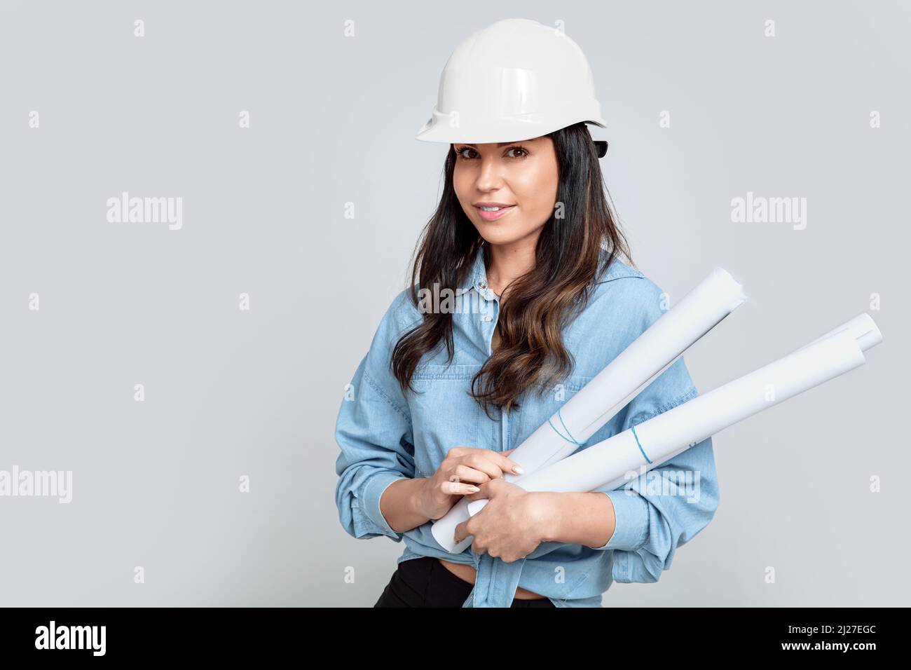 Young attractive female architect with white helmet and architectural ...