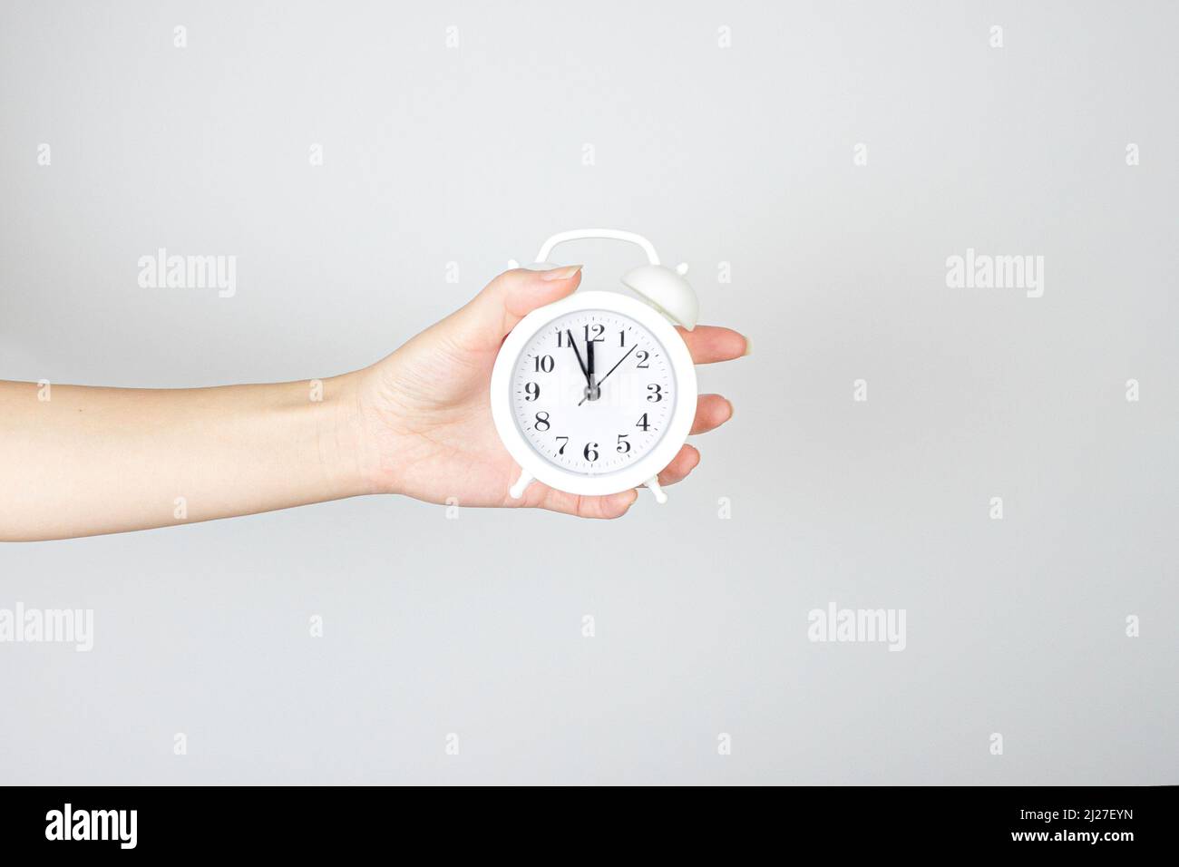 The concept of time management and discipline. Alarm clock on a hand ...