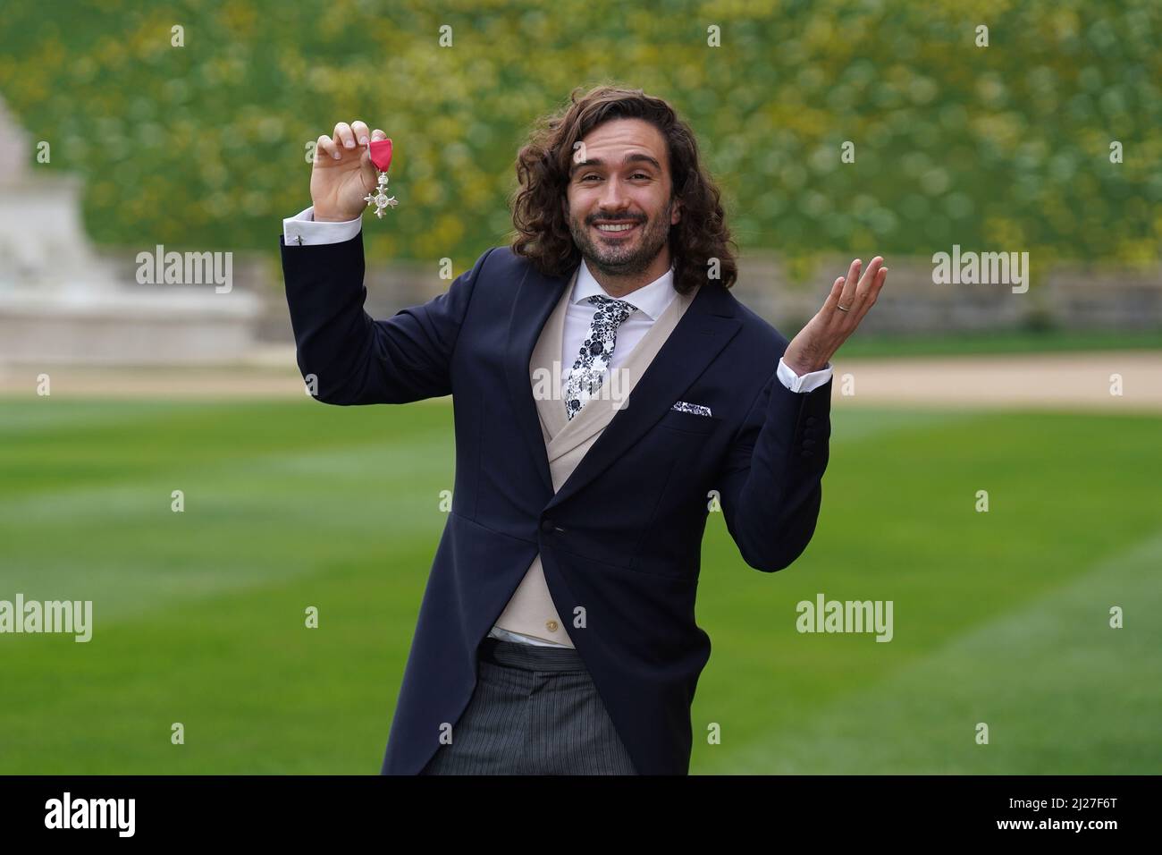 Joe Wicks after receiving his MBE medal from the Prince of Wales during ...