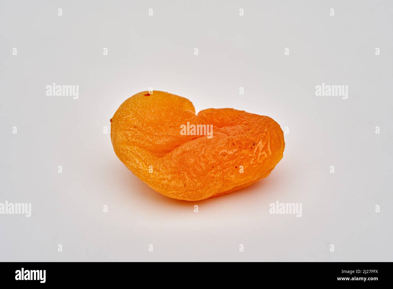 One single dried apricot isolated on white background Stock Photo - Alamy