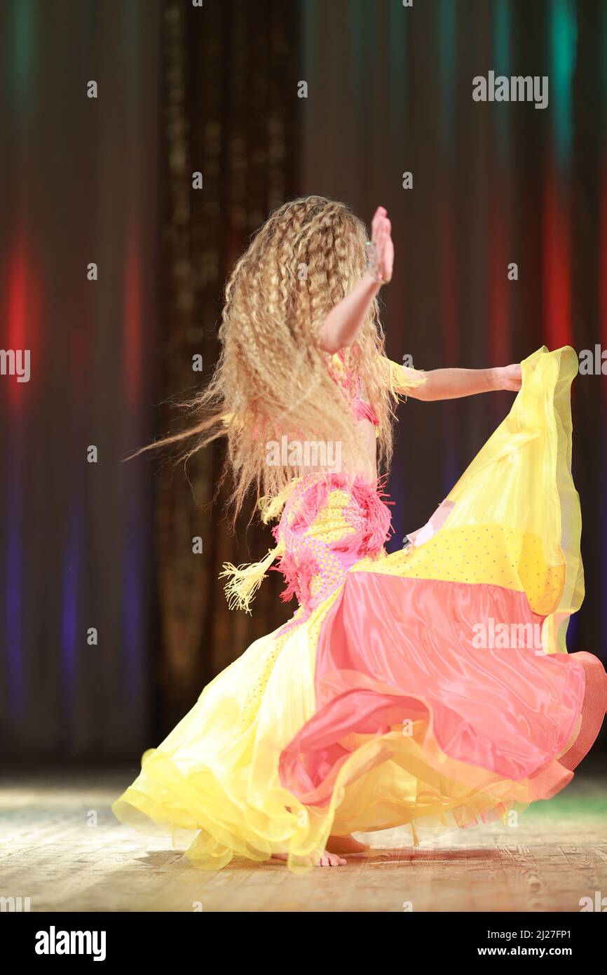 Girls dancers perform on stage with multi-colored lights. Backstage ...