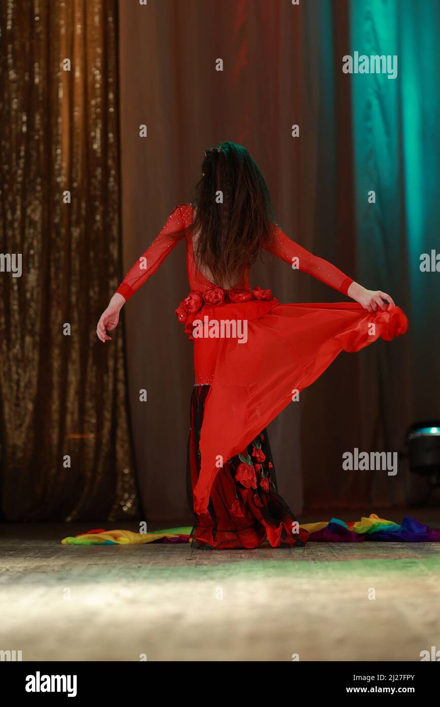 Girls dancers perform on stage with multi-colored lights. Backstage ...