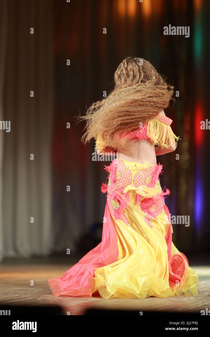 Girls dancers perform on stage with multi-colored lights. Backstage ...