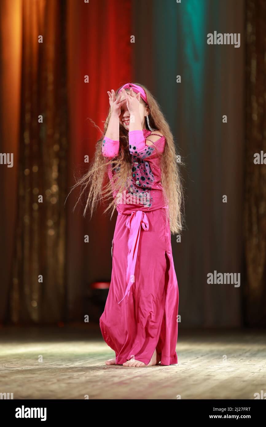Girls dancers perform on stage with multi-colored lights. Backstage ...