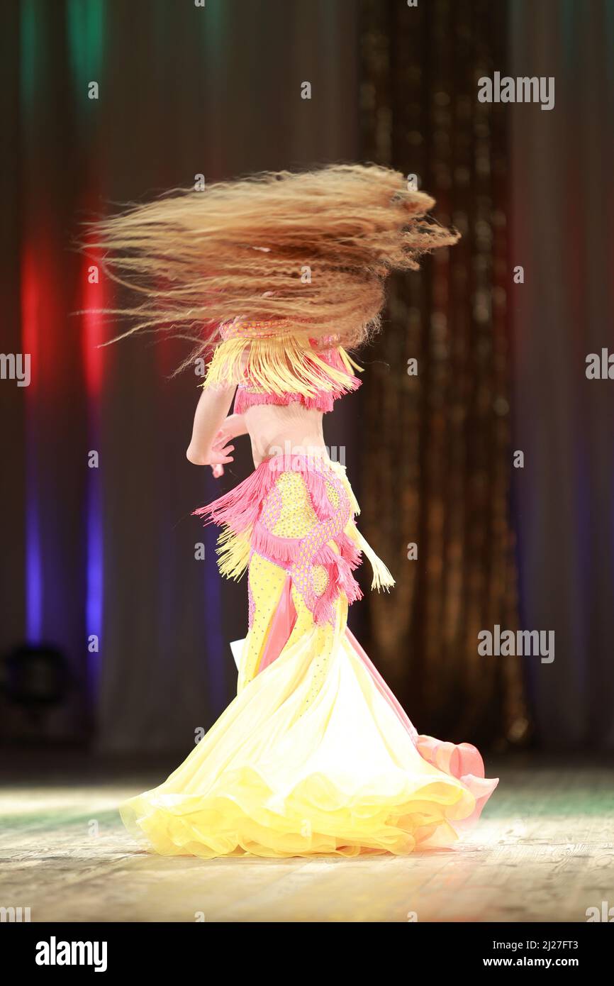 Girls dancers perform on stage with multi-colored lights. Backstage ...