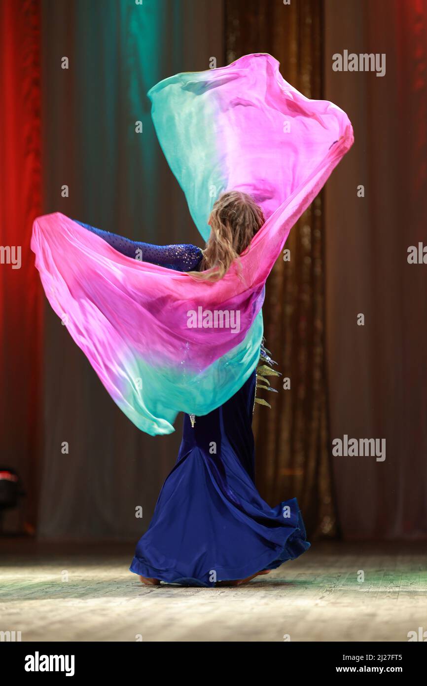 Girls dancers perform on stage with multi-colored lights. Backstage ...