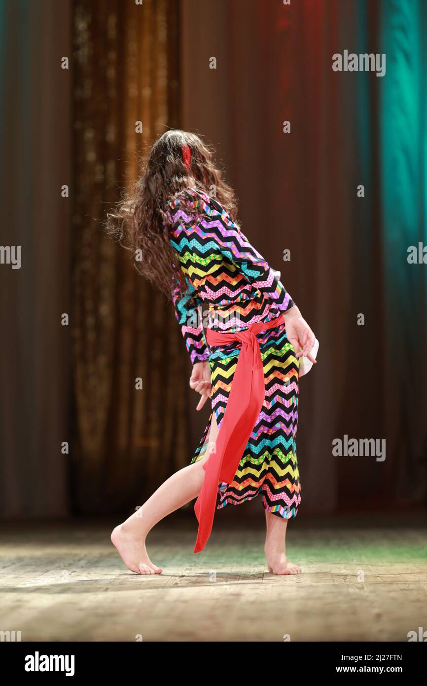 Girls dancers perform on stage with multi-colored lights. Backstage ...