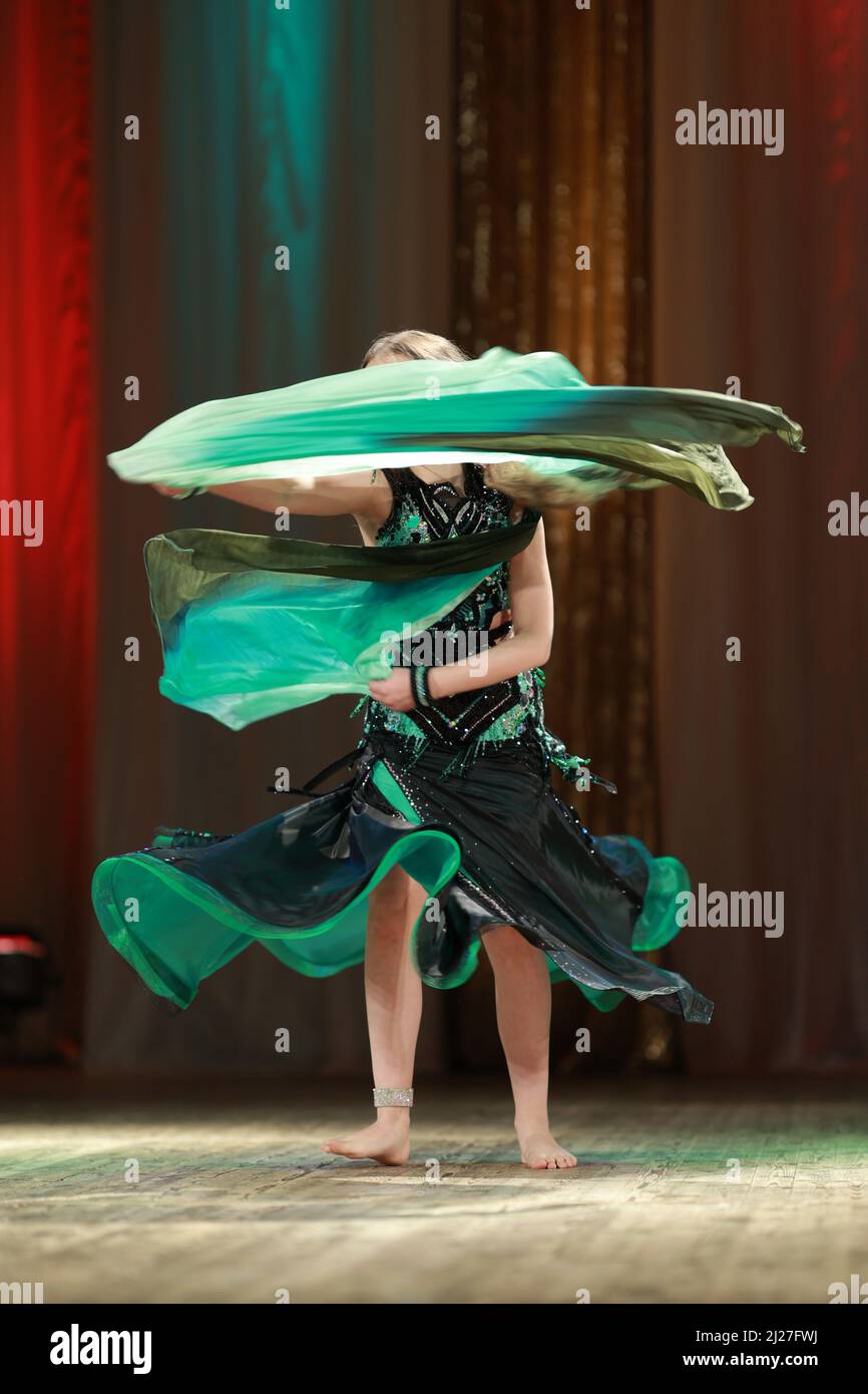Girls dancers perform on stage with multi-colored lights. Backstage ...